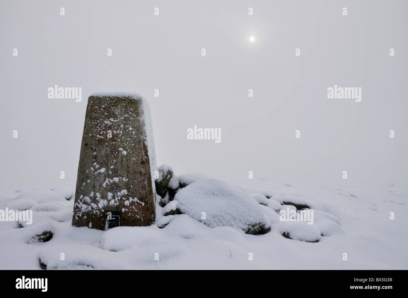 Snowy summit trig point and fence, Mwdwl-eithin, Hiraethog, Wales Stock ...