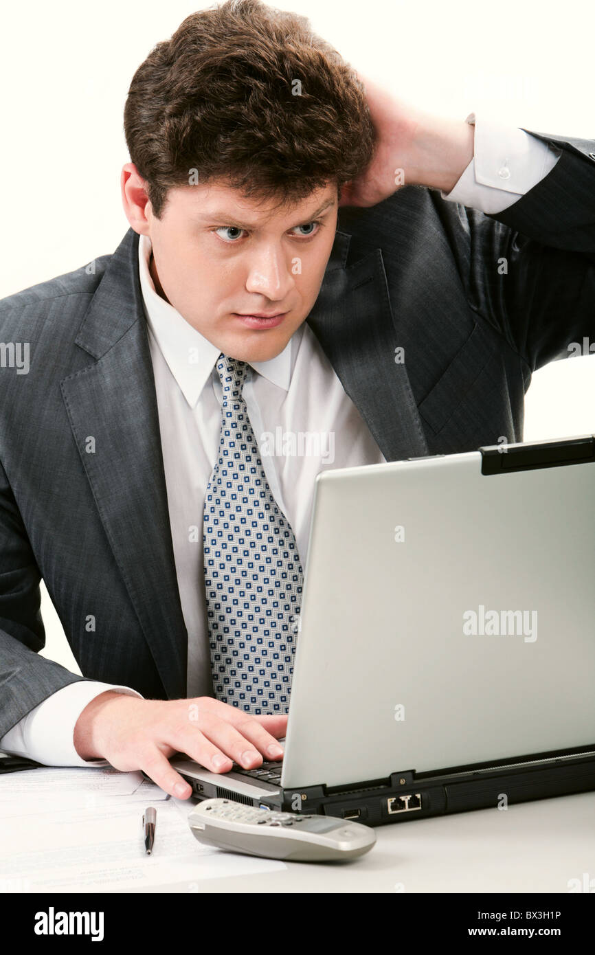 Portrait of smart businessman looking at laptop monitor with ...