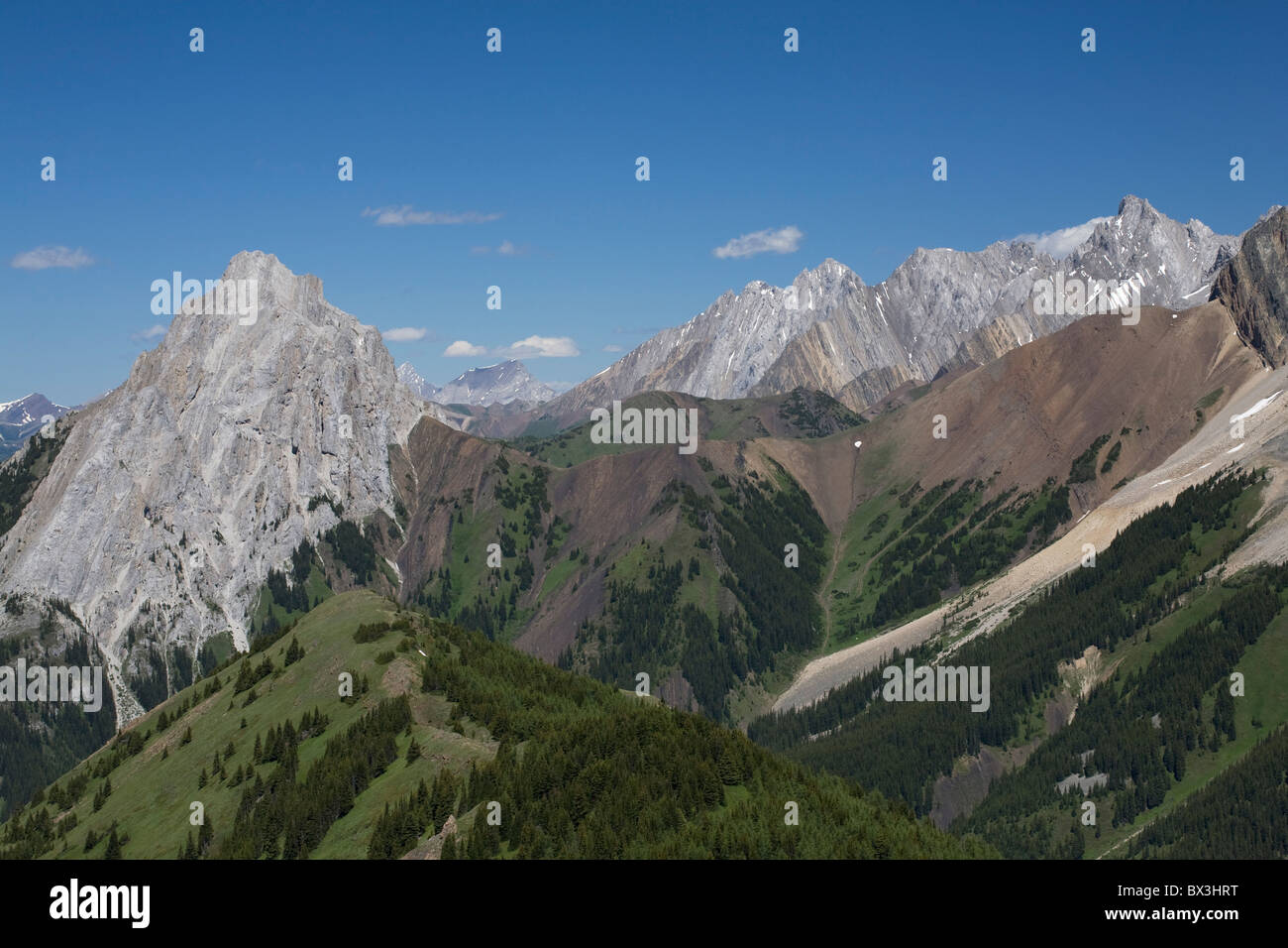 Mountain Range With Green Meadows And Blue Sky; Alberta, Canada Stock ...