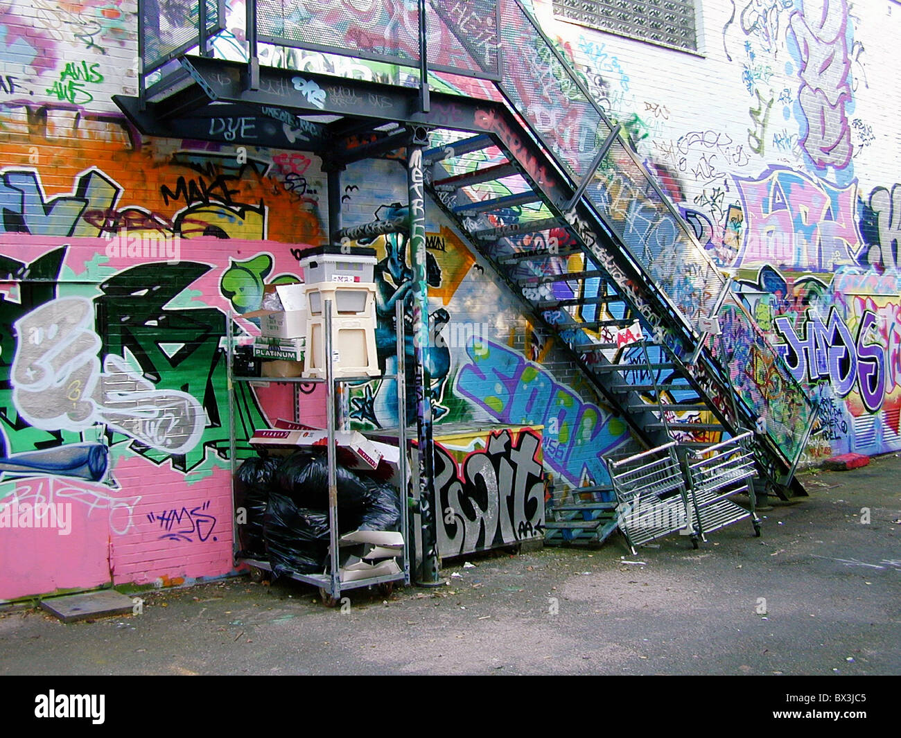 graffiti sprayed damage to property wall spraying Stock Photo - Alamy