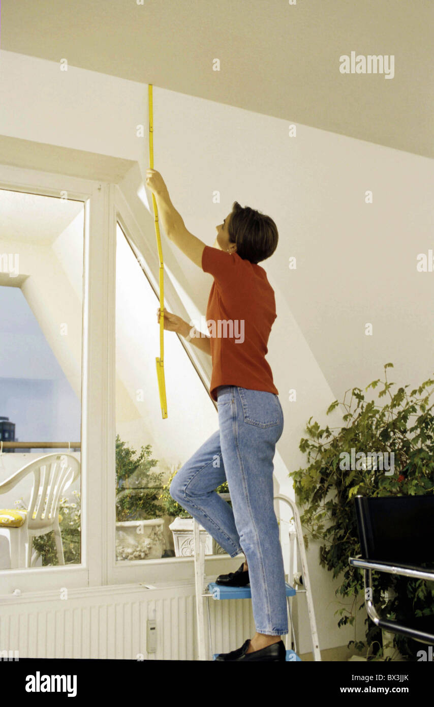 woman inside home measuring window masses measuring apartment folding ...