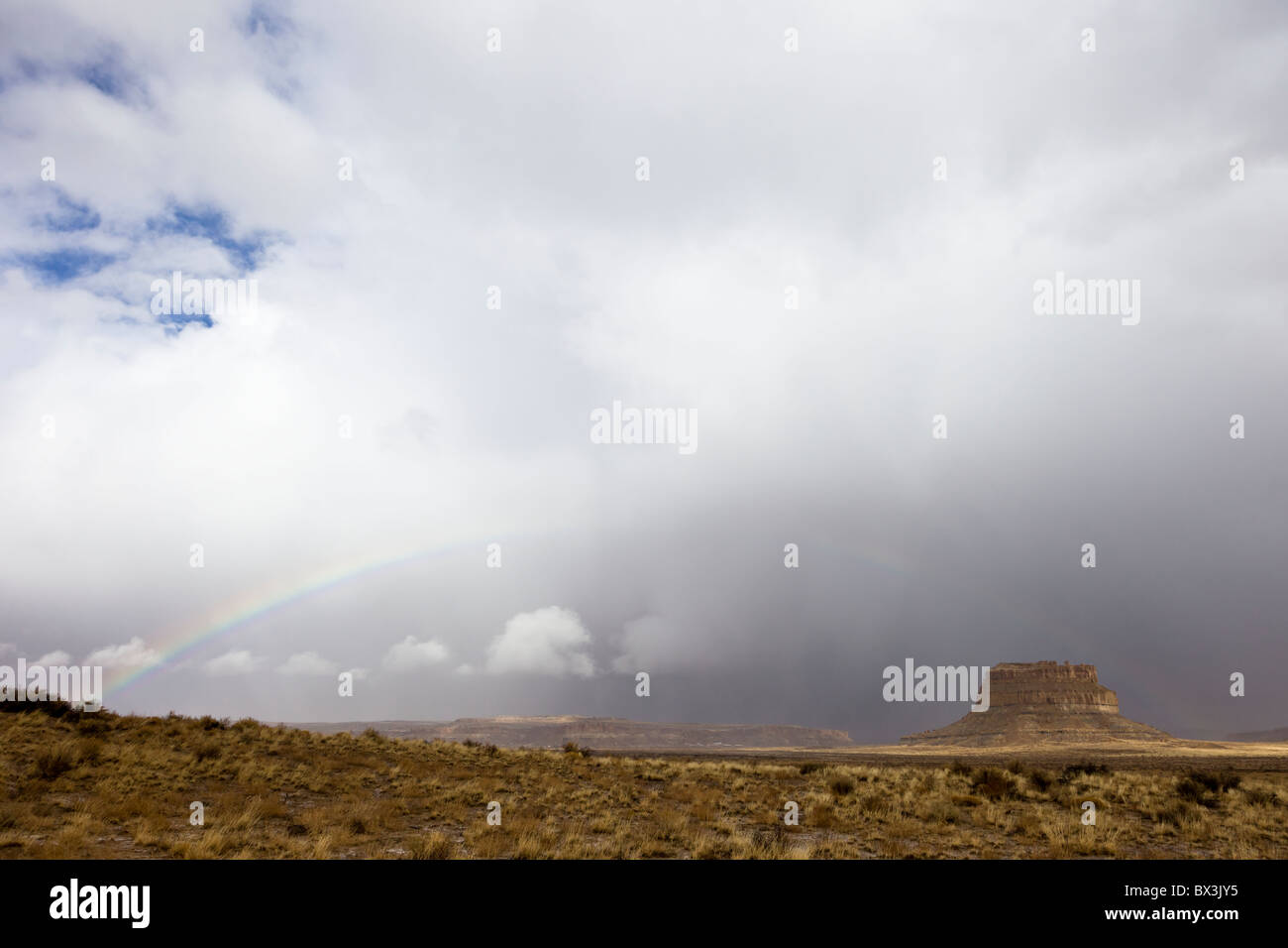 Storm clouds with rainbow form over Fajada Butte in Chaco Canyon in The ...
