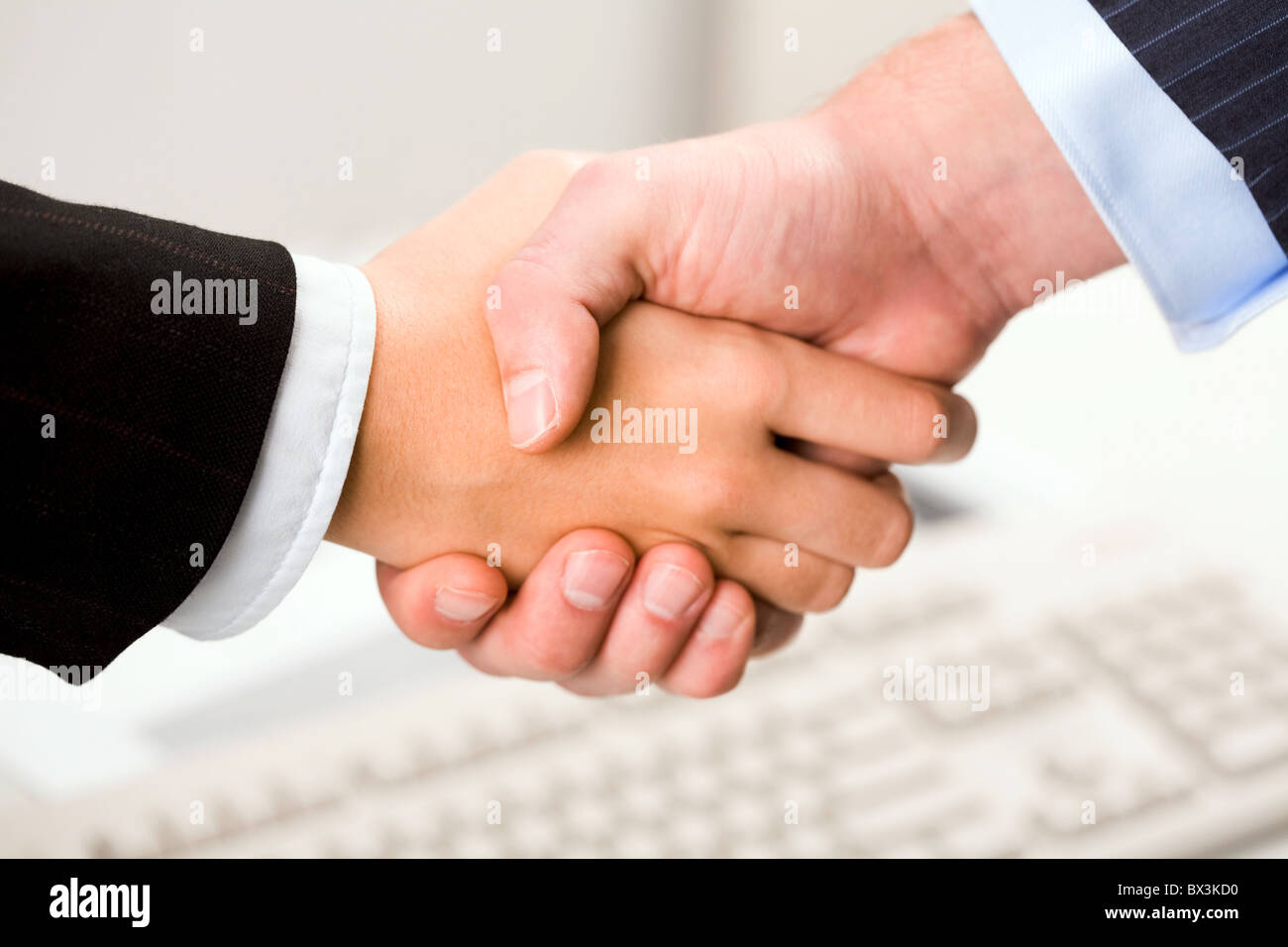 Photo of handshake of business partners after signing promising ...