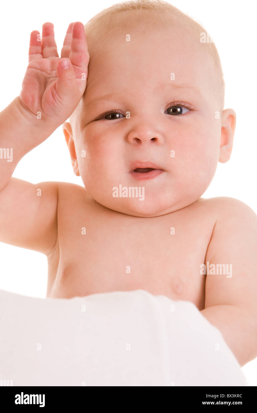 Photo of sweet baby touching forehead with funny expression Stock Photo ...