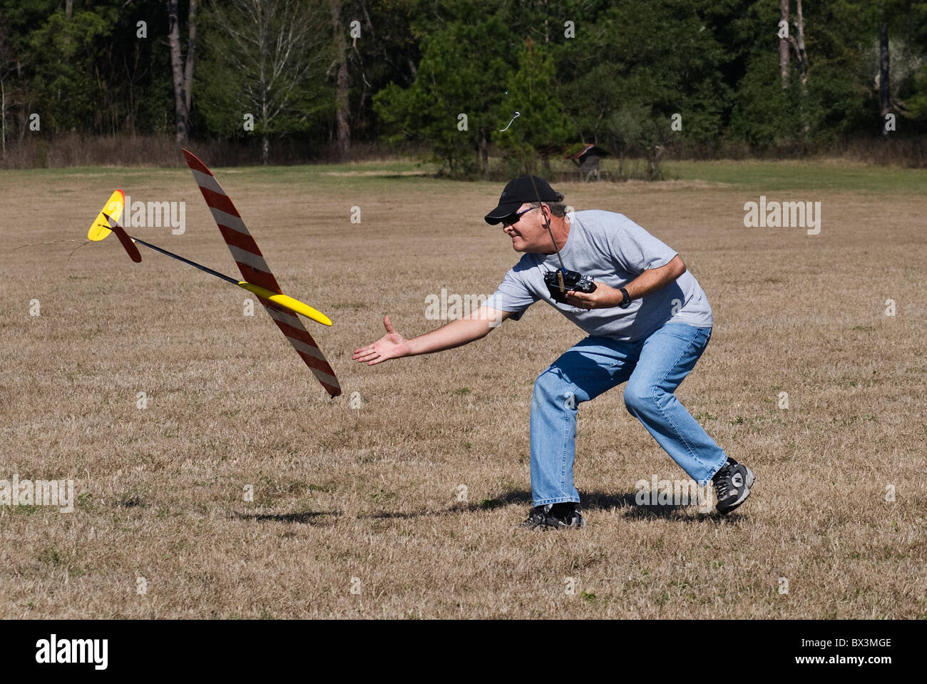 man catches his radio controlled hand launch glider in flight during ...