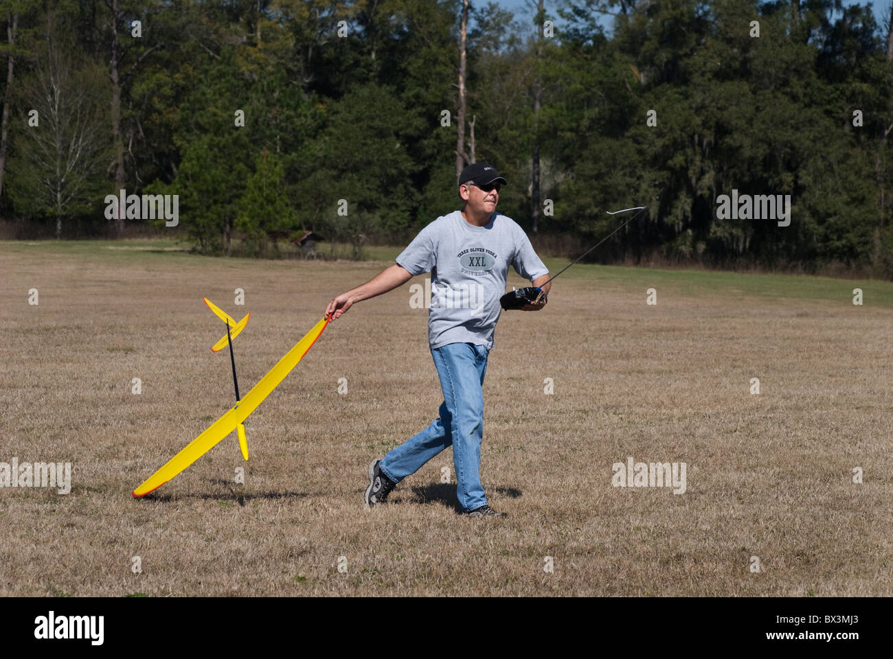 man prepares to launch his radio controlled hand launch glider during ...