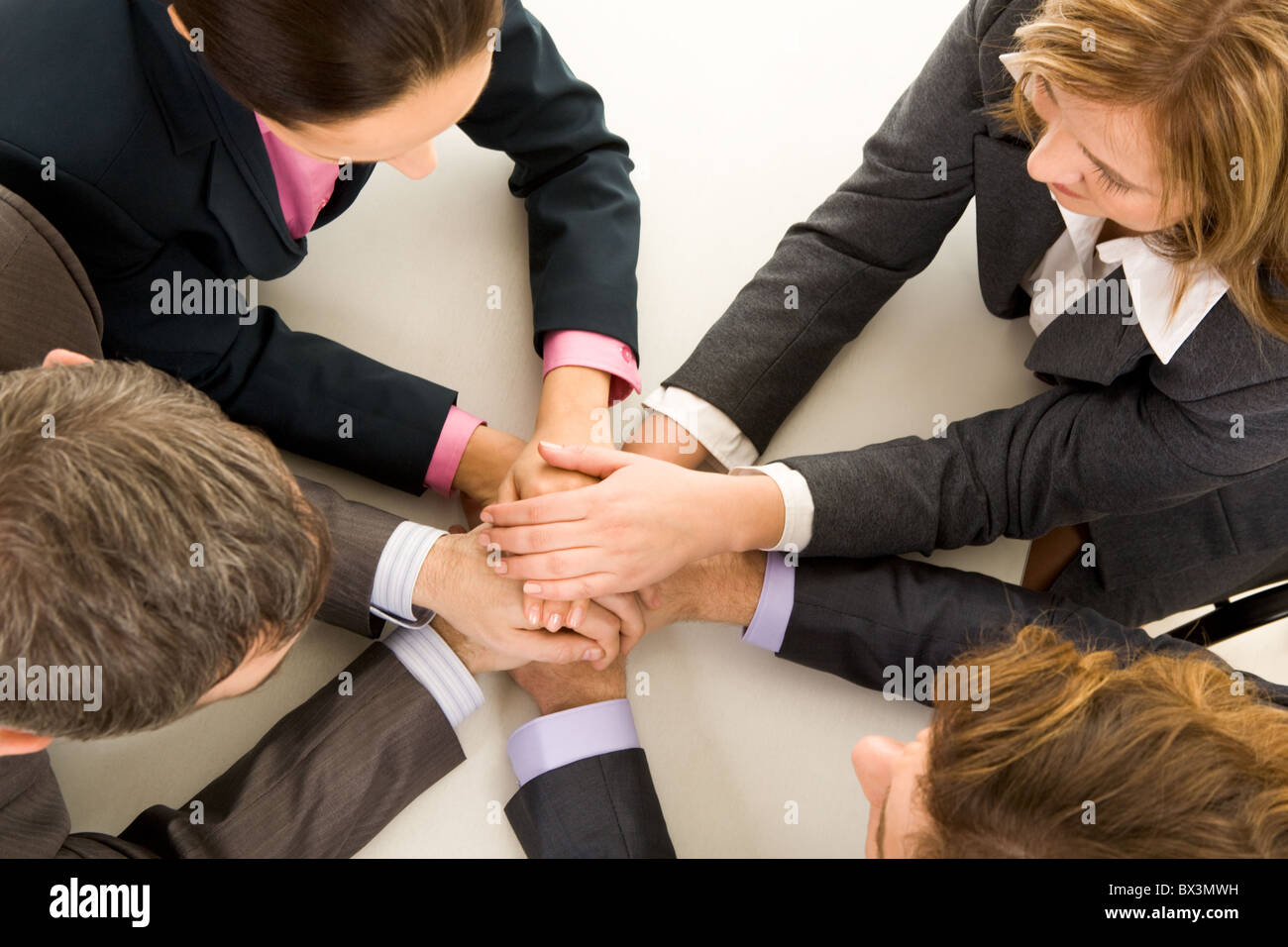 Image of business people keeping hands on top of each other at ...