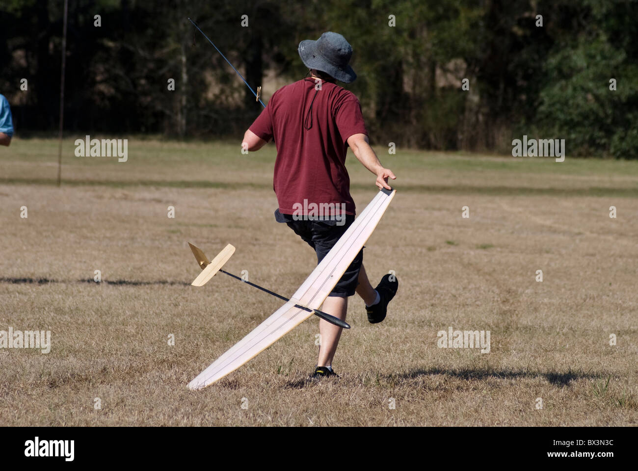 man prepares to launch his hand launch glider during competition ...