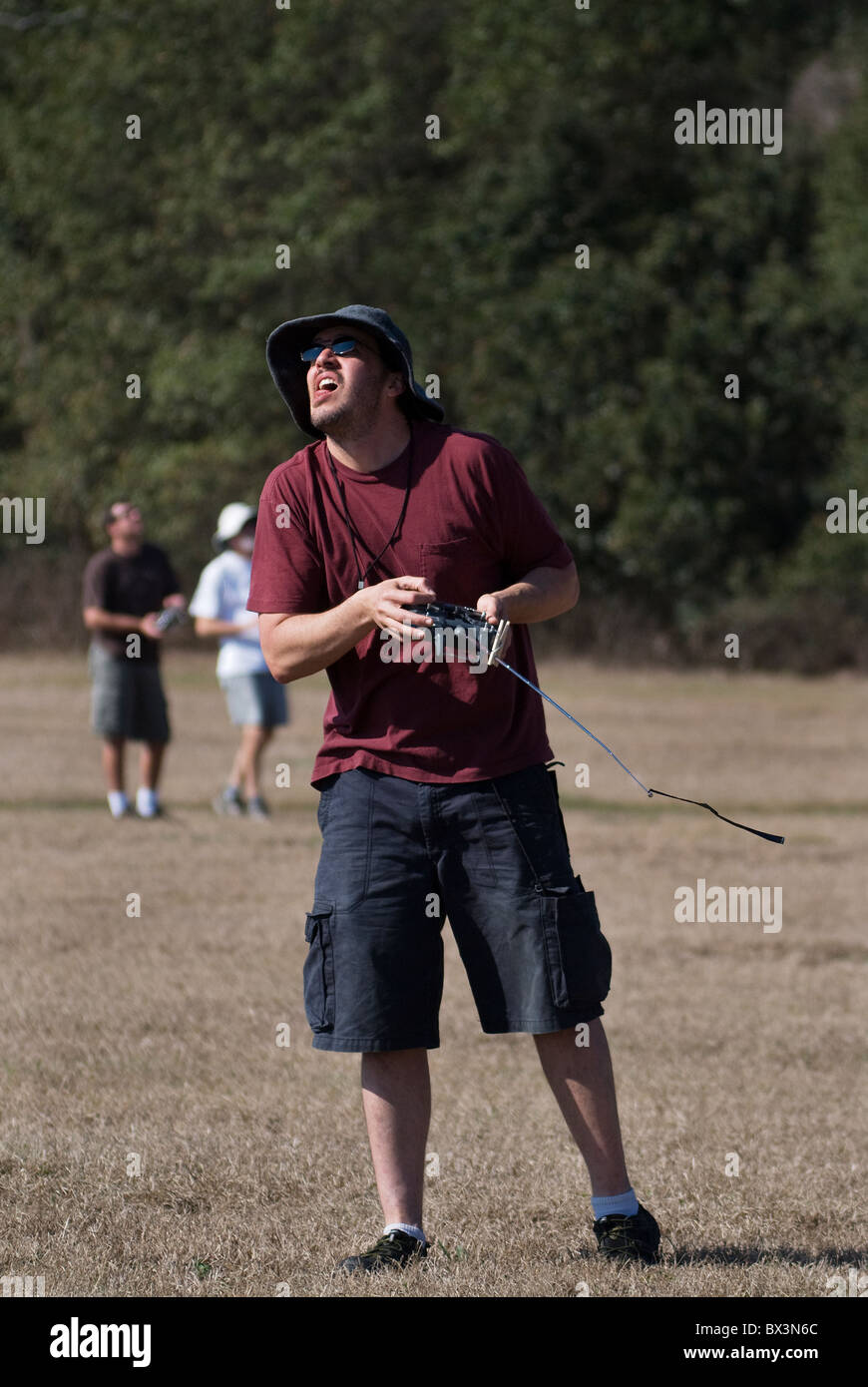 man uses radio control device to fly his hand launch glider during ...