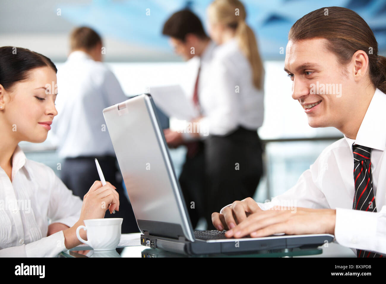 Portrait of busy chief working with laptop on background of ...