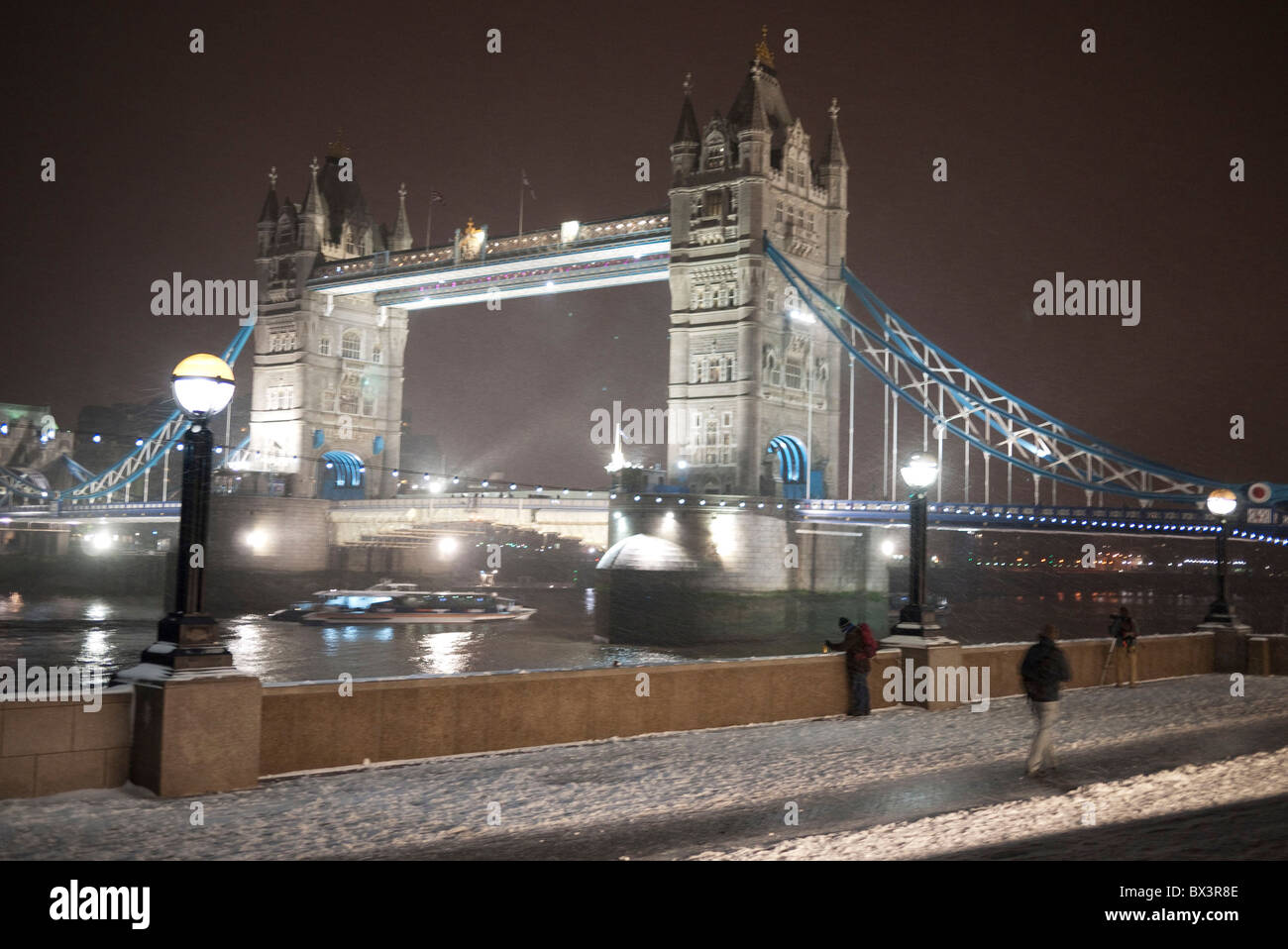 Night scene of Tower Bridge in London on a cold winter evening as snow ...