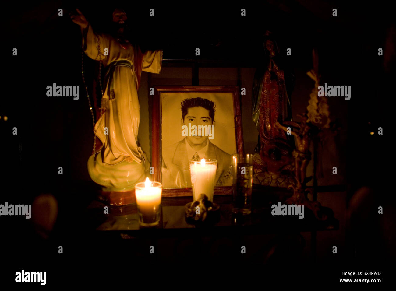 Candles, religious figures and a photograph of a deceased young man ... Candles, religious figures and a photograph of a deceased young man ...