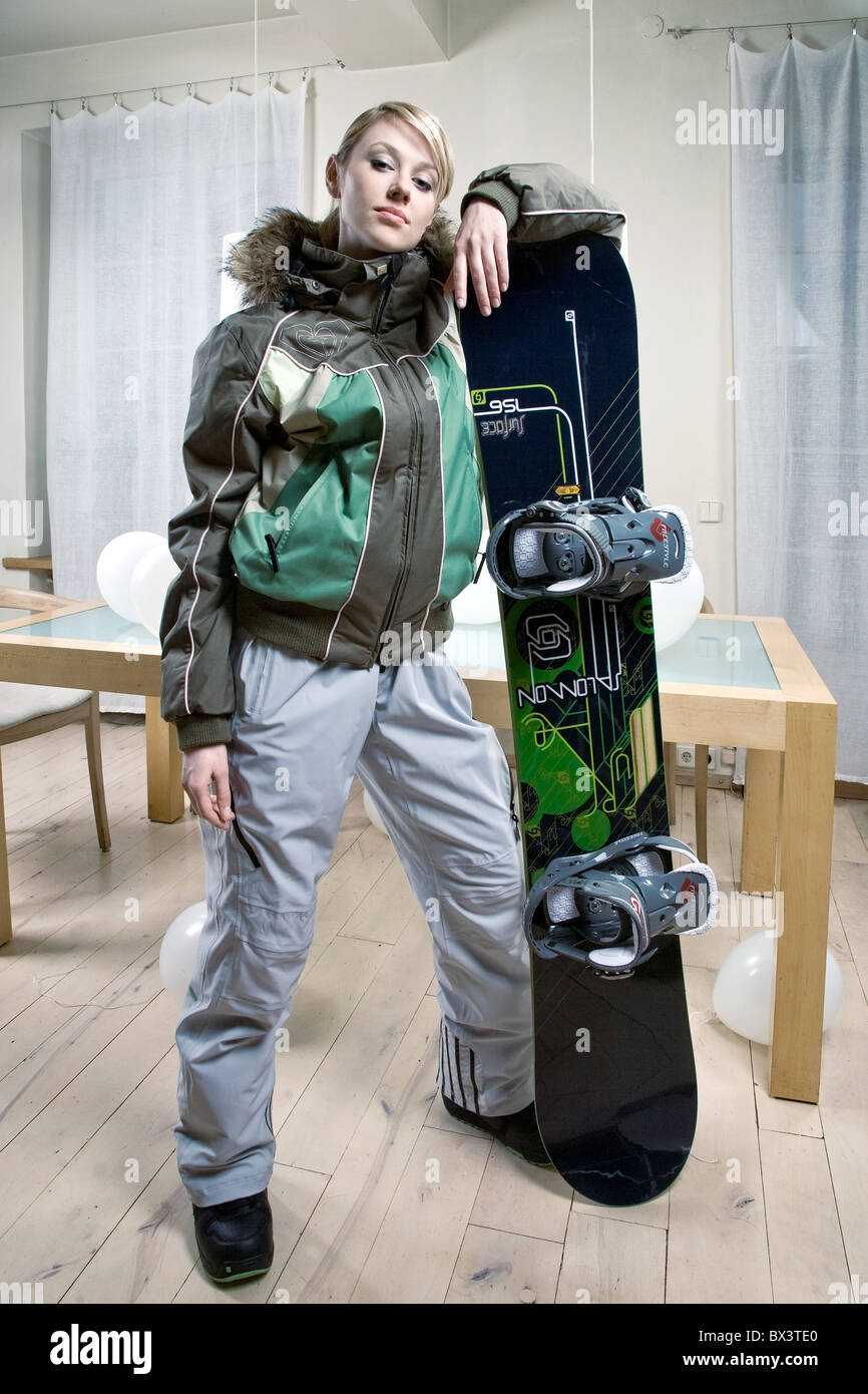 Young woman at home with snowboarding equipment Stock Photo - Alamy