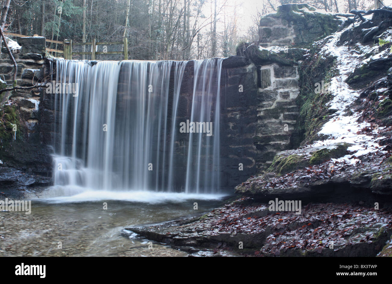 Bersham waterfall and River Clywedog with snow and autumn leaves near ...
