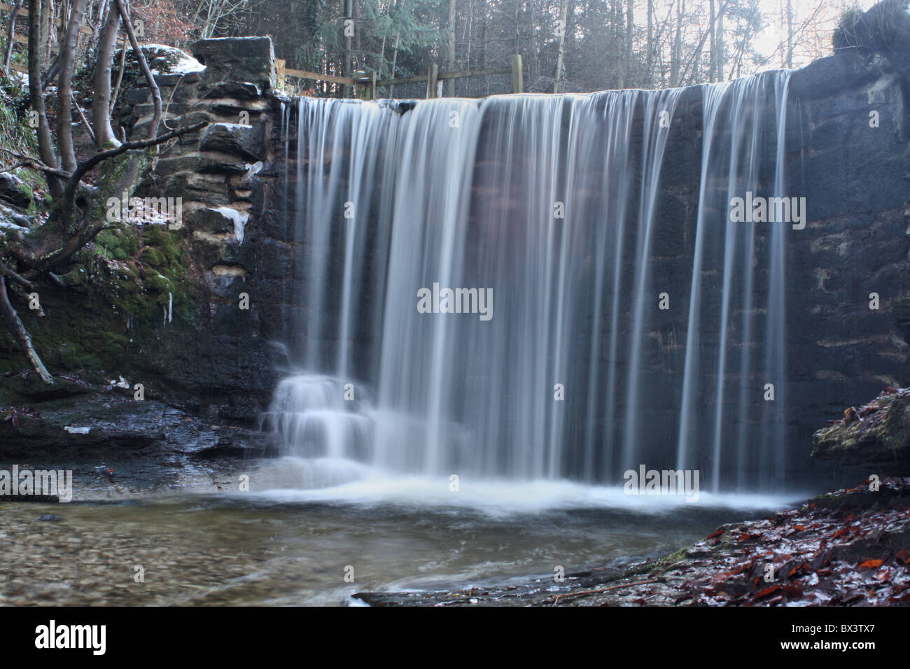 Bersham waterfall and River Clywedog with snow and autumn leaves near ...