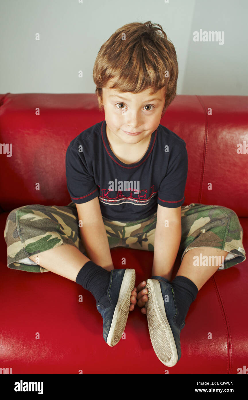 Little boy sitting on a sofa Stock Photo - Alamy