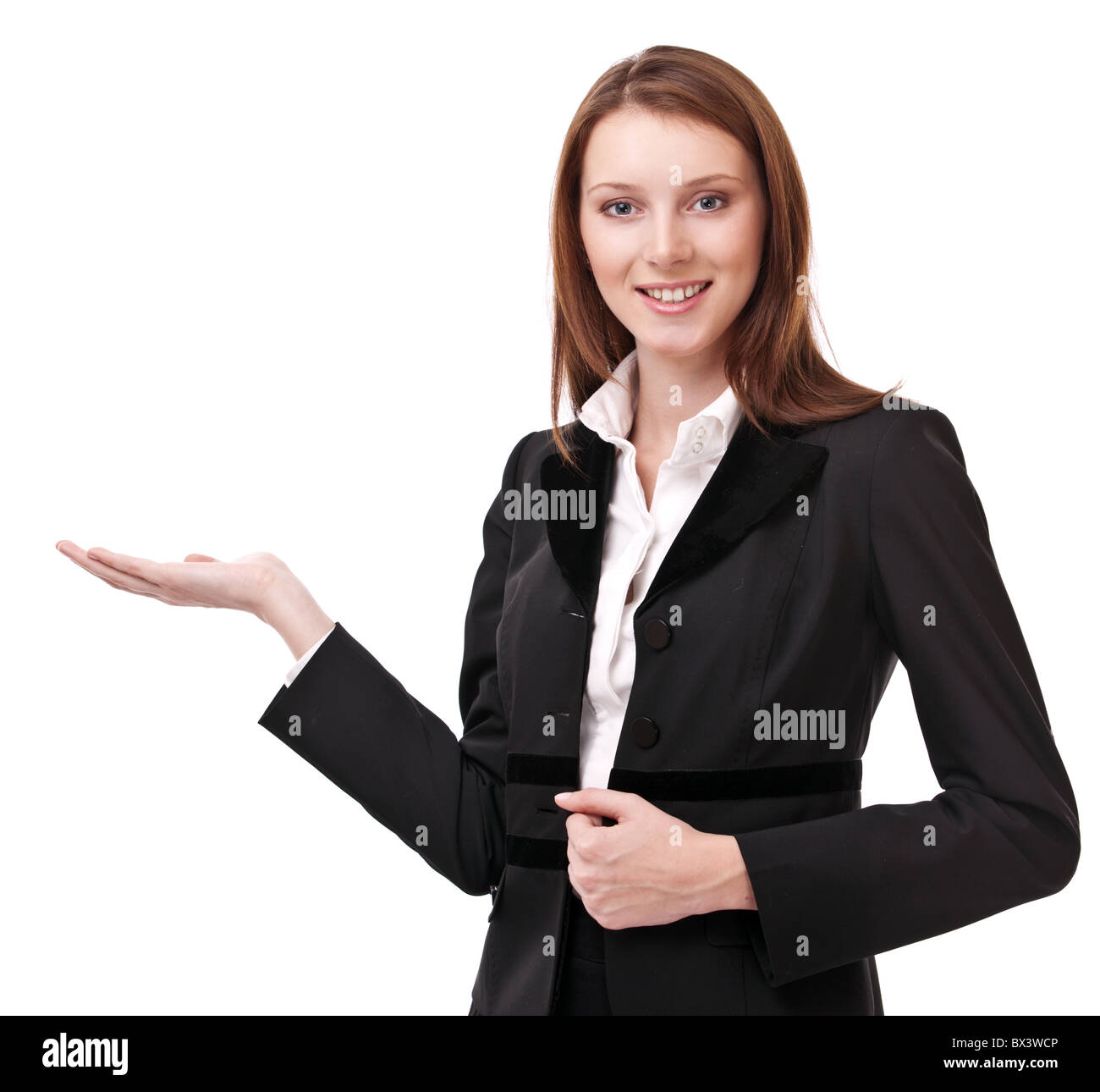 Young woman in business suit shows her empty palm. Isolated on a white ...