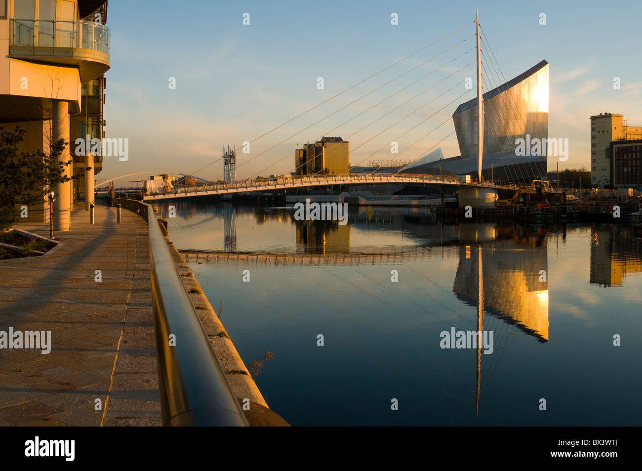 Imperial War Museum North and swing footbridge reflected in the ...