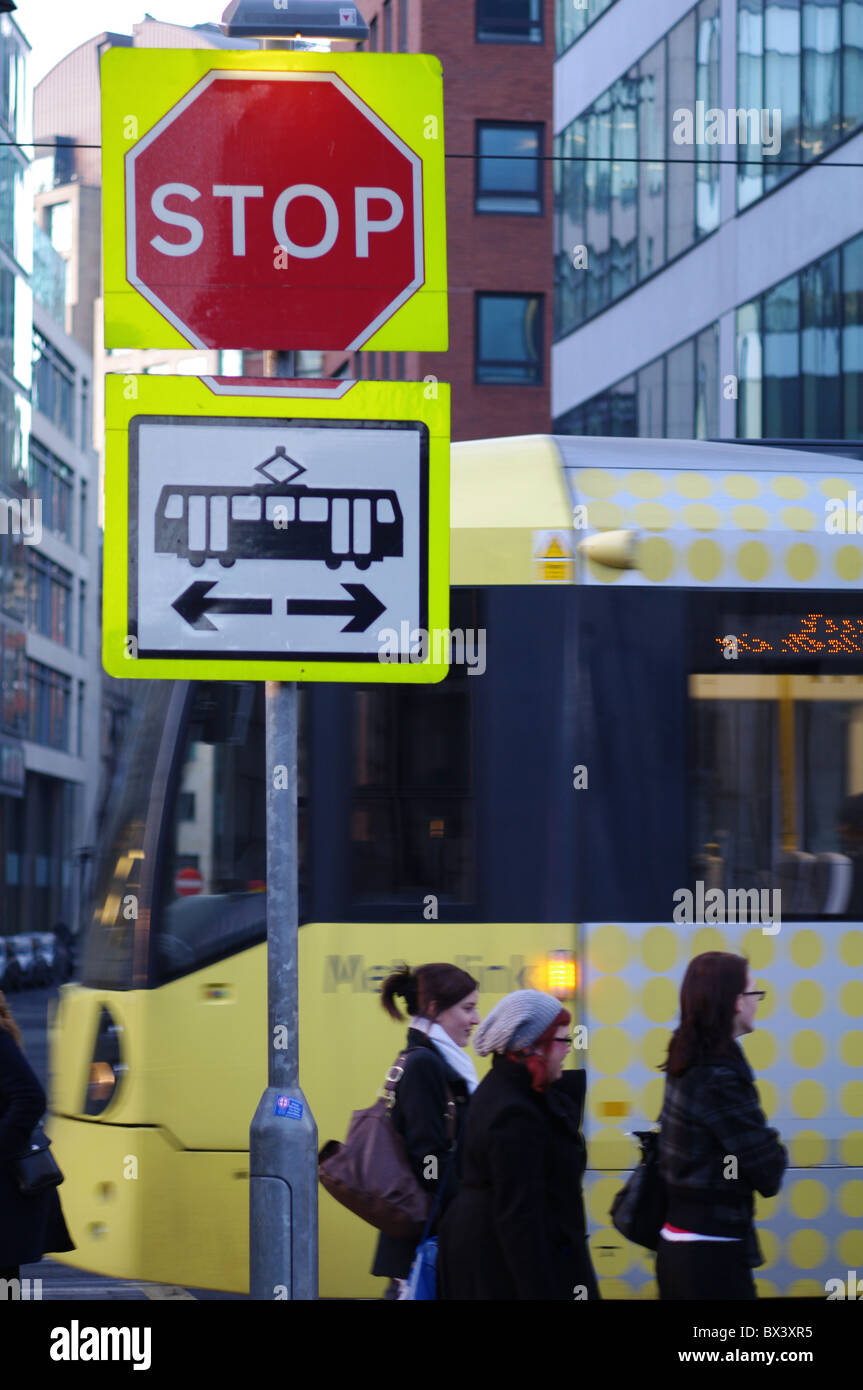 Metrolink tram passing stop sign in Manchester Stock Photo - Alamy