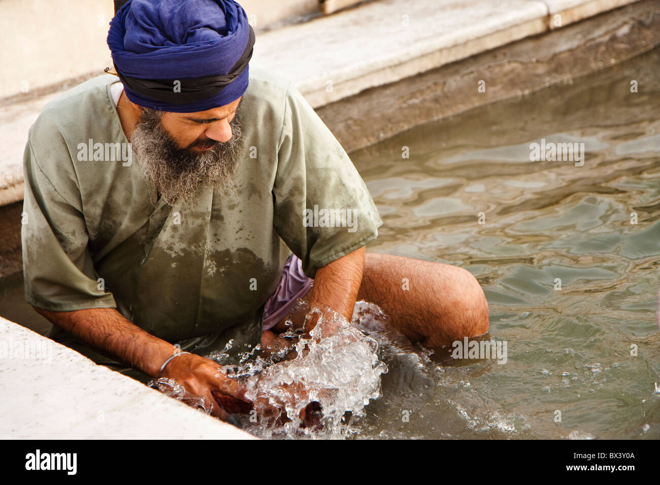 A Sikh washing the pool at the Golden Temple, Amritsar, Punjab, India ...