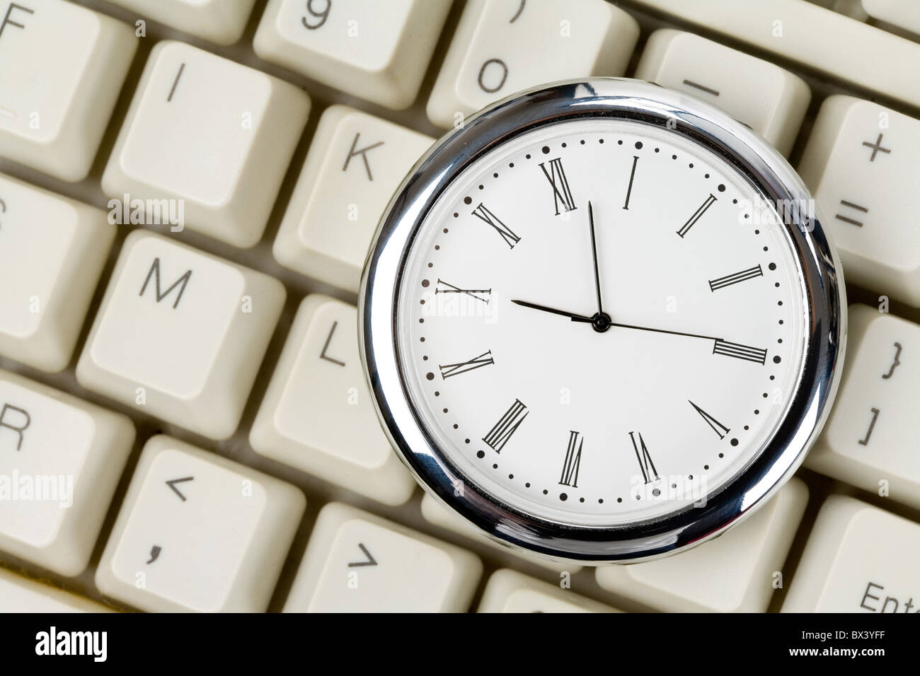 Clock and computer Keyboard close up Stock Photo - Alamy