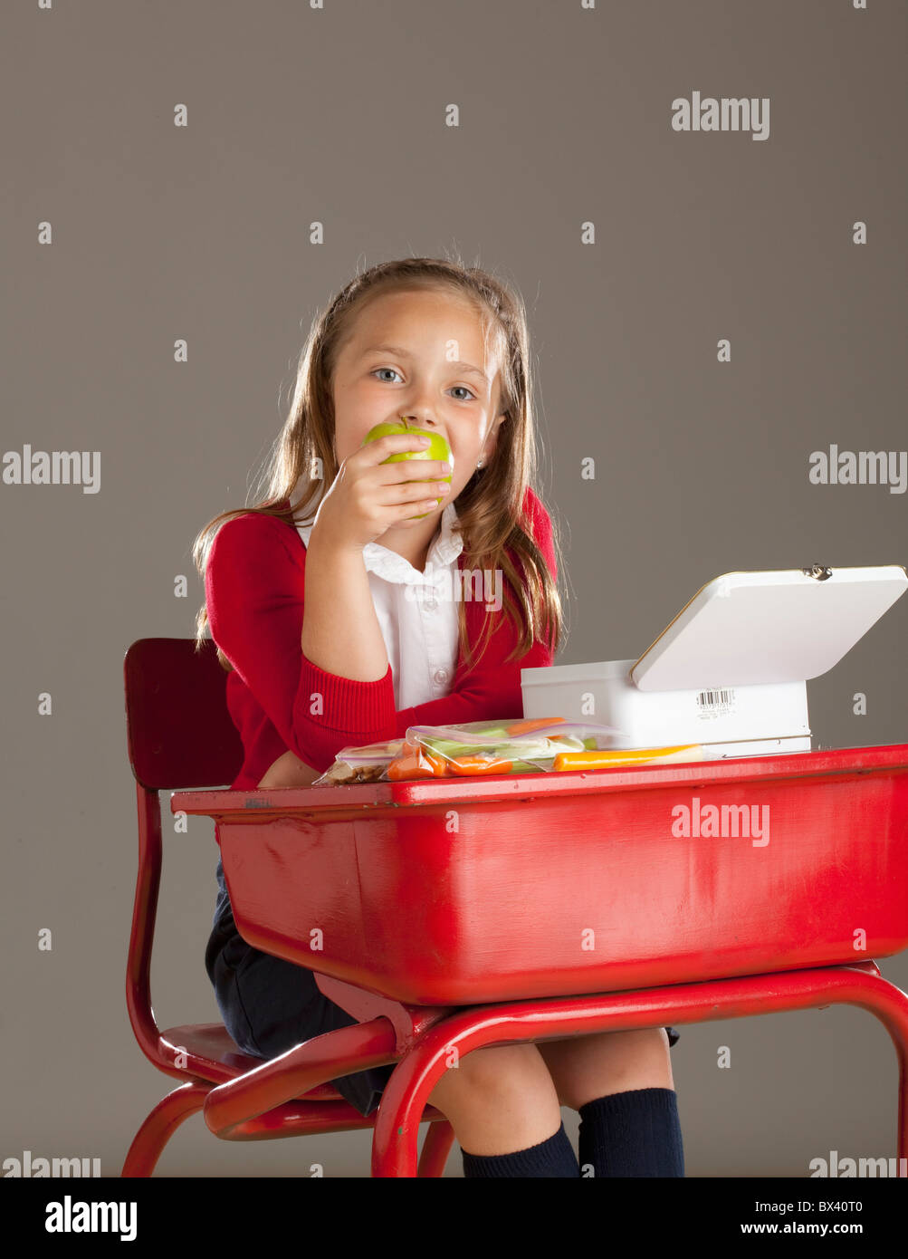 A Girl Eating Her Lunch At Her Desk Stock Photo - Alamy