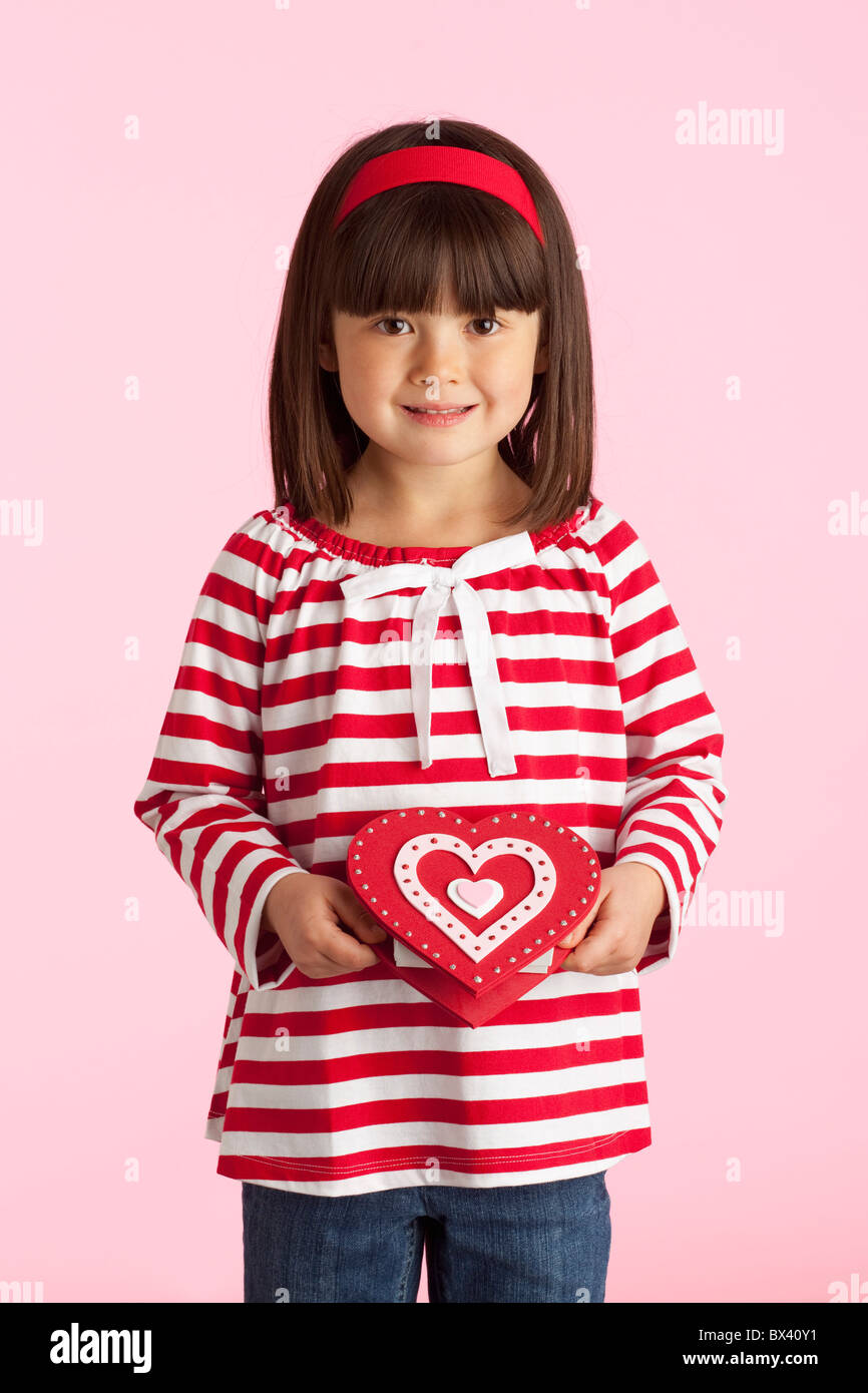 A Girl Holding A Heart Shaped Box Stock Photo - Alamy