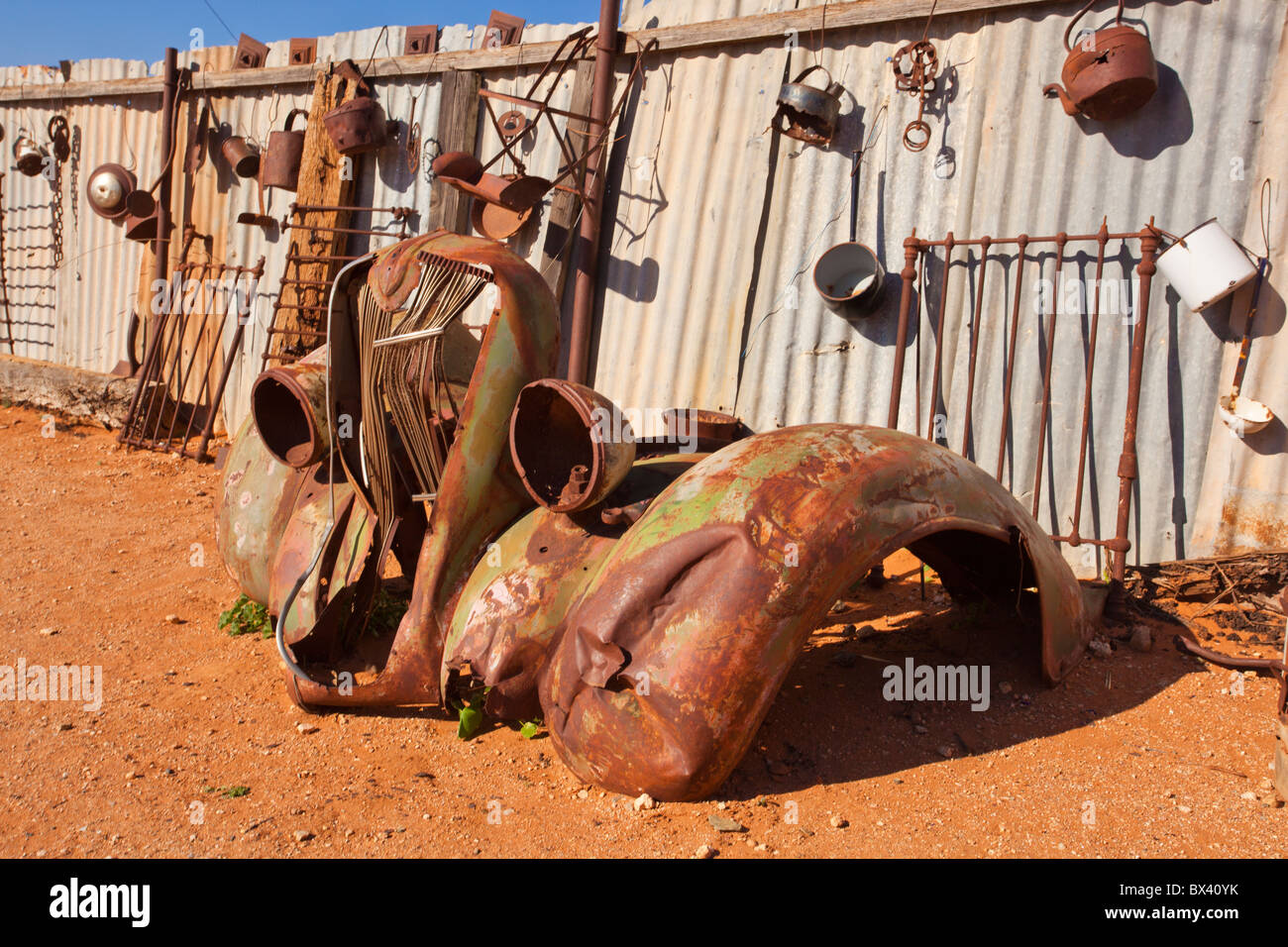 A collection of junk hanging on a corrugated iron fence at a cafe in ...