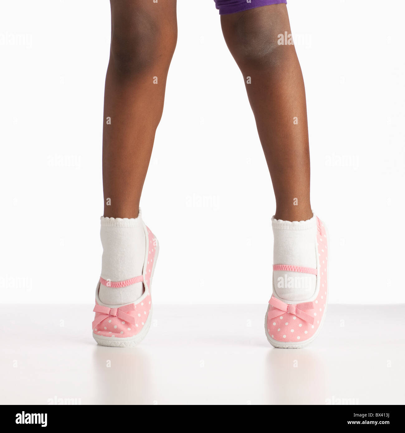 A Girl Standing On Her Toes Wearing Pink Shoes Stock Photo - Alamy