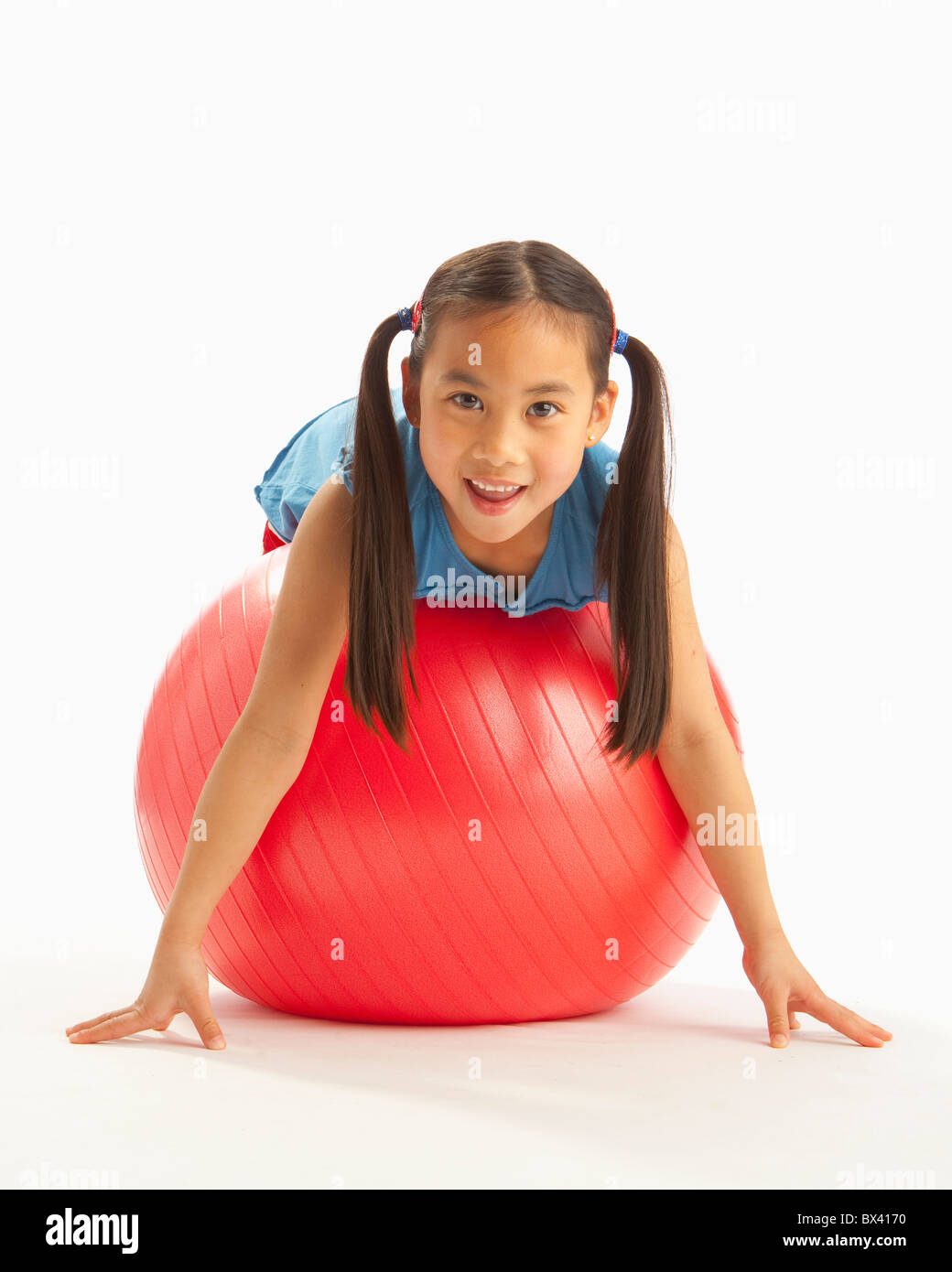 A Girl Laying On A Large Red Exercise Ball Stock Photo - Alamy