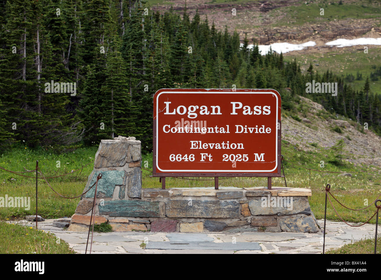 Marker, signpost for Logan Pass, notating the Continental Divide and ...