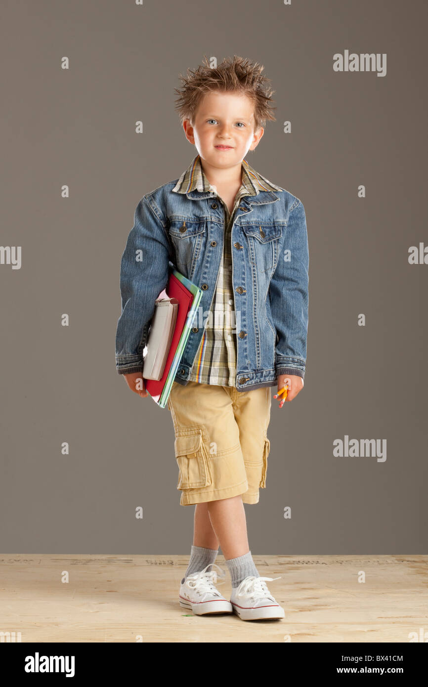 A Boy Holding His Notebooks And Pencils Stock Photo - Alamy