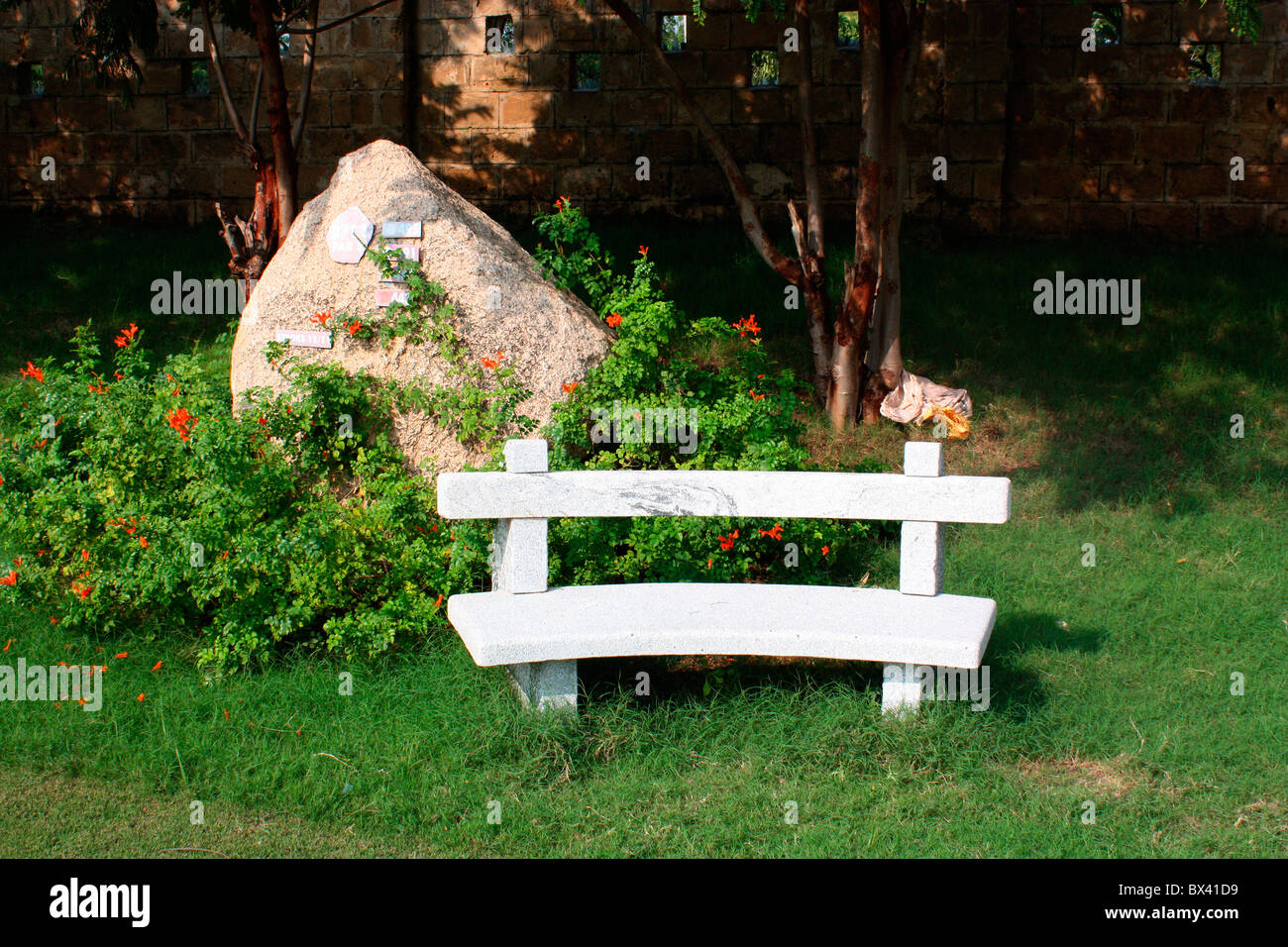A white wooden bench in a garden Stock Photo - Alamy