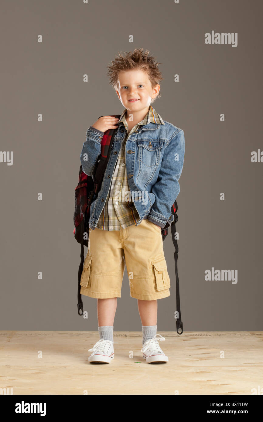 A Boy Carrying A Backpack Stock Photo - Alamy