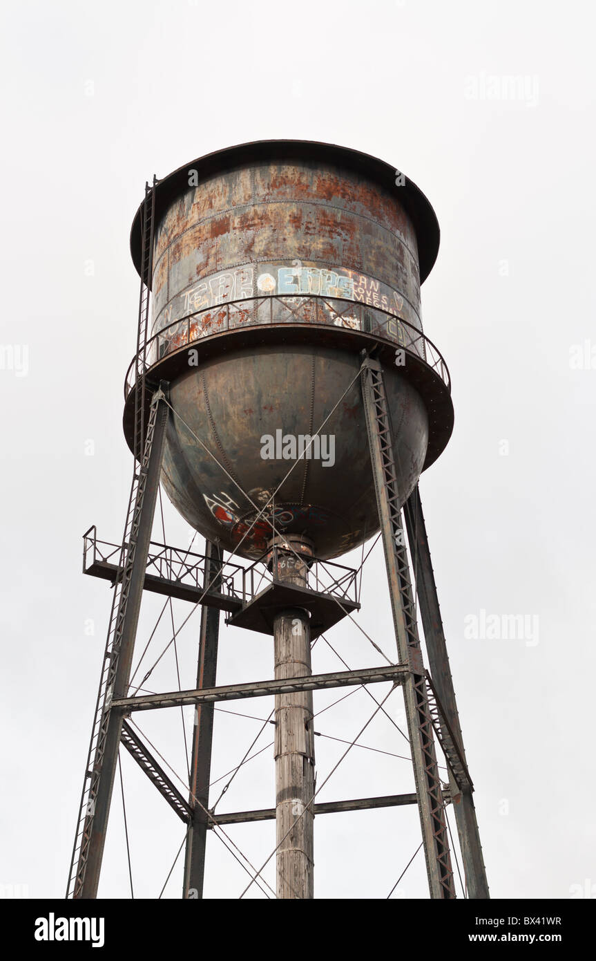 An old water tower covered with rust and graffiti Stock Photo - Alamy