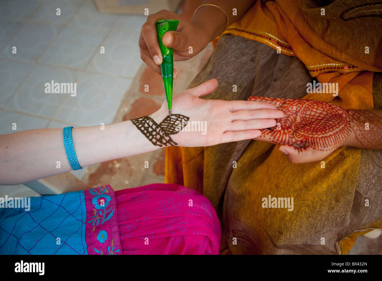 A Woman Doing Henna Painting On Another Woman's Arm; Sathyamangalam ...