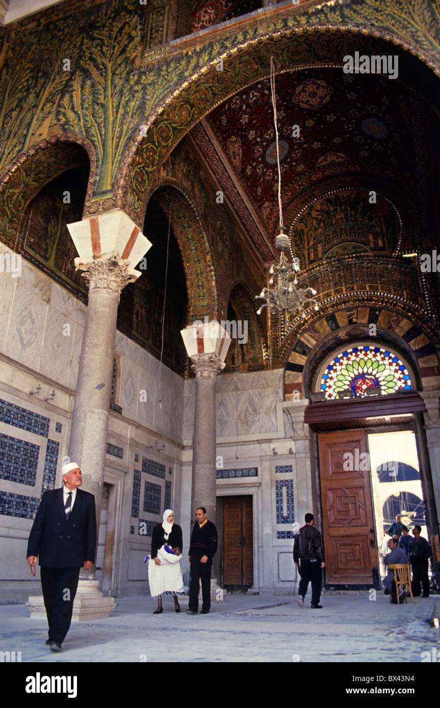 People walking under a decorative ceiling while entering the Umayyad ...