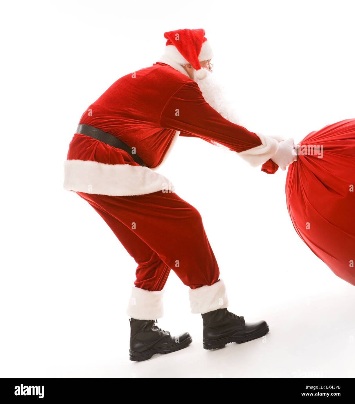 Portrait of smart Santa carrying heavy big red sack with presents Stock ...