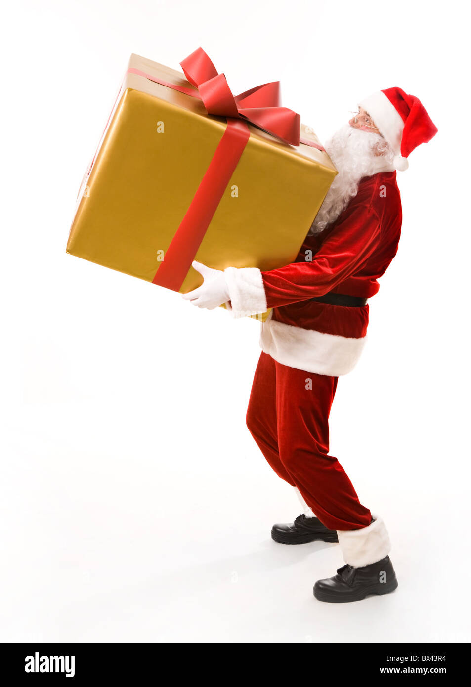 Photo of strong Santa Claus holding heavy giftbox over white background ...
