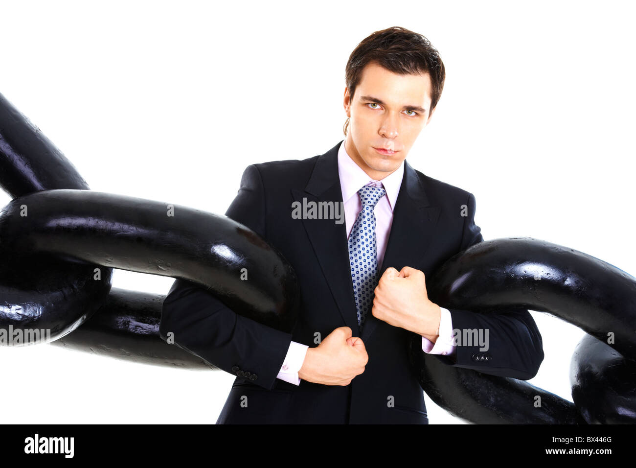 Portrait of powerful businessman with several sections of huge chain ...