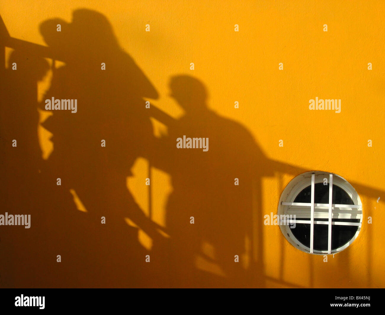 people pedestrian shadow throw shade silhouettes wall yellow window ...