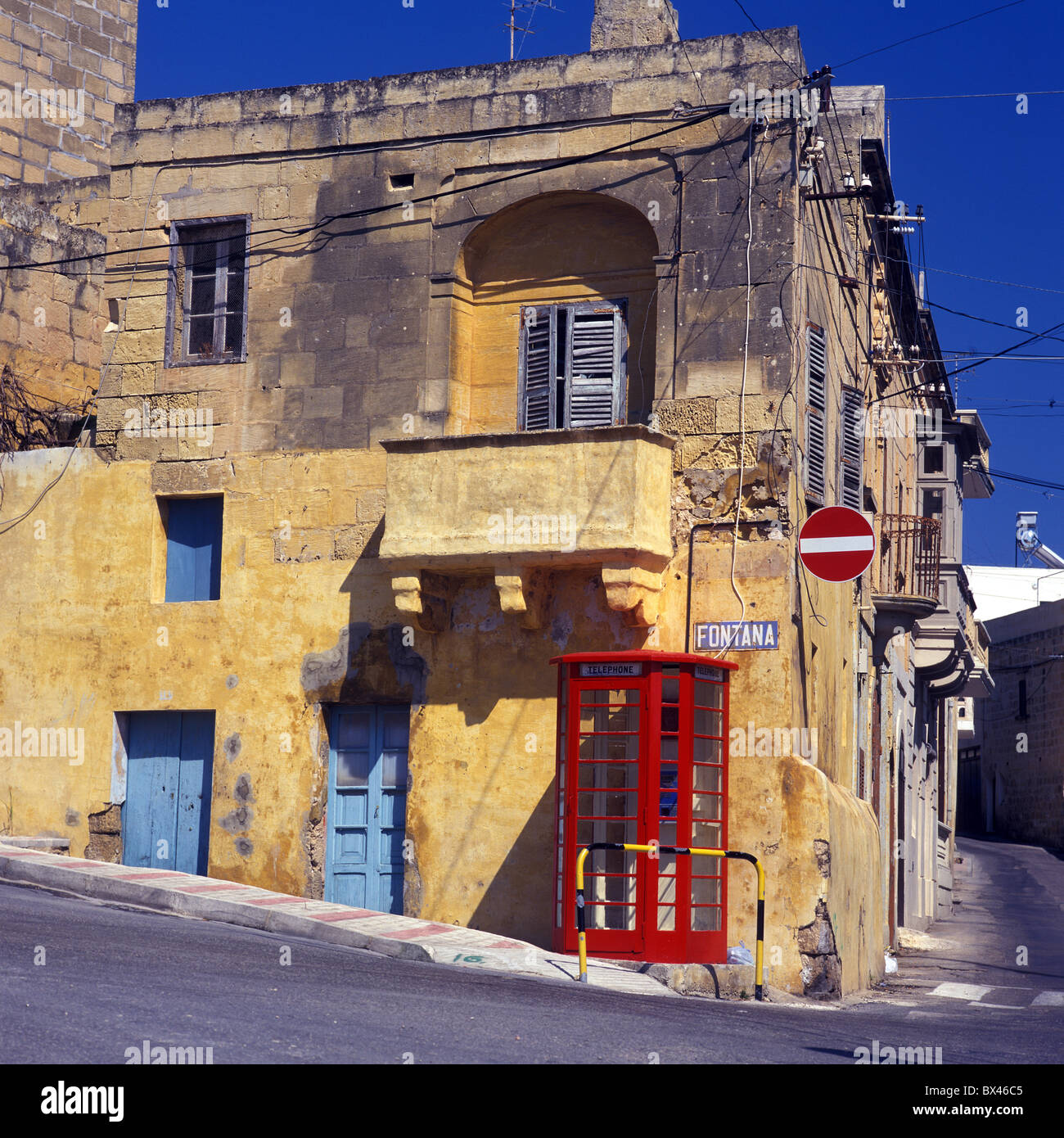 Malta house home street cable phone booth red to wood door blue balcony ...