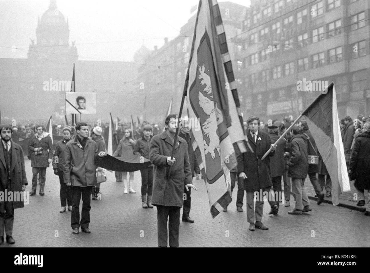 Students carry national flags during a march in his honour across ...