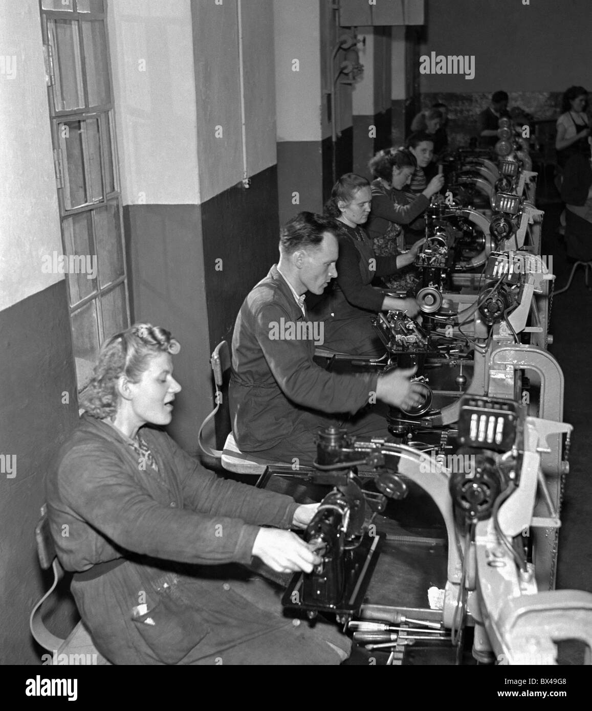Czechoslovakia - Bynov 1950. Sewing machine factory. Worklers assemble ...