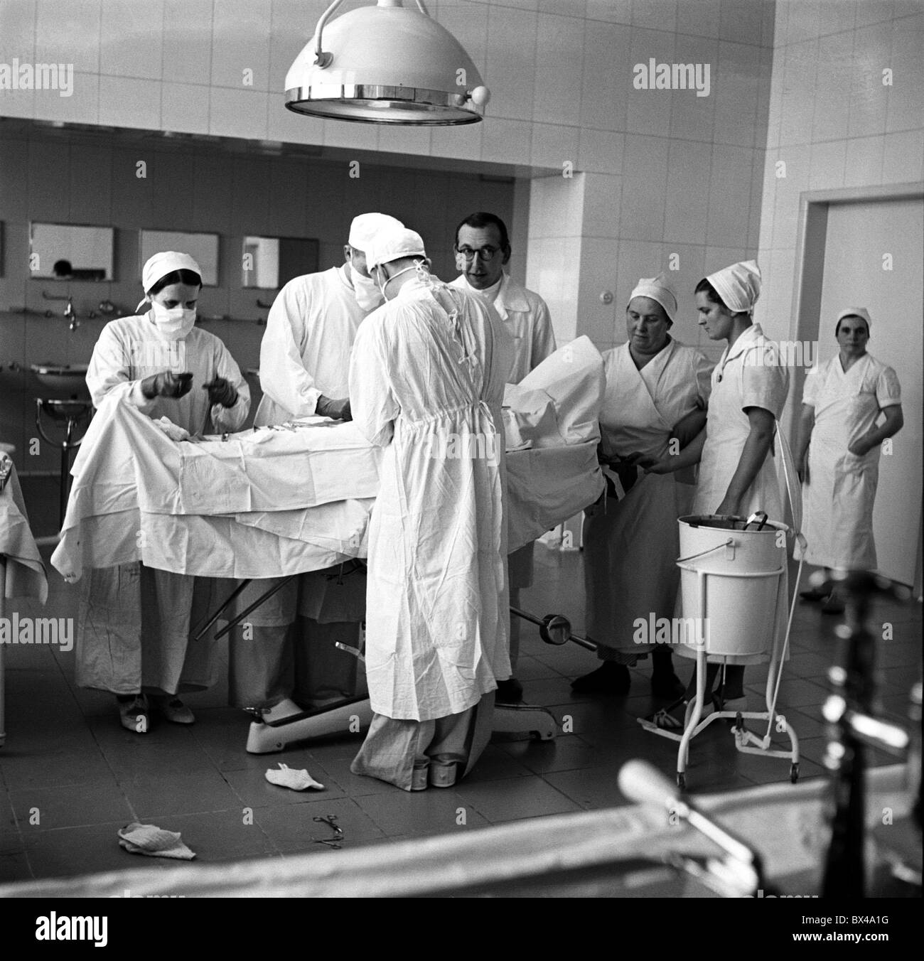 Prague, Masaryk Hospital. Doctors performing surgery in operating room ...