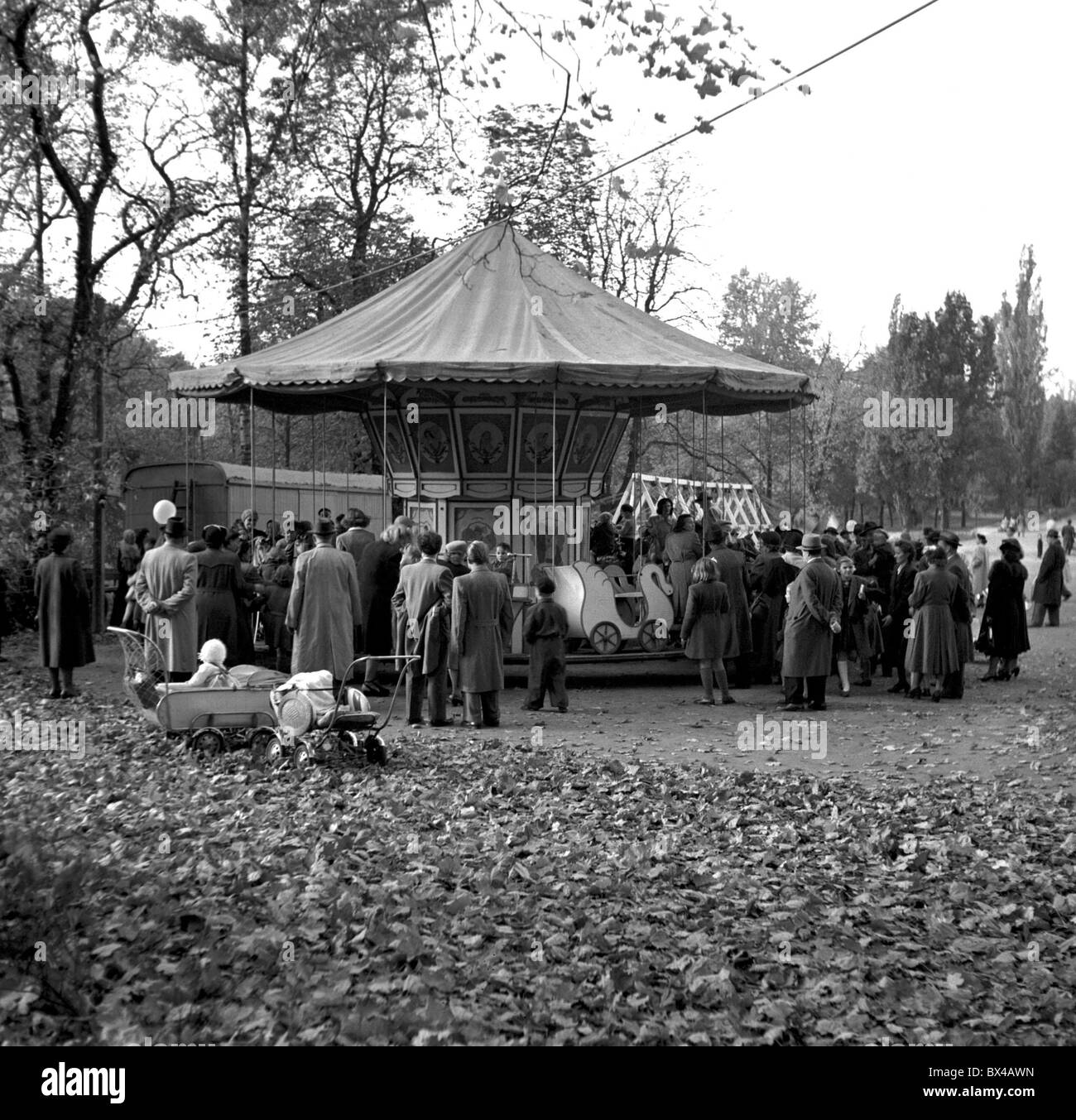 Prague 1949, people wait in line to buy carrousel tickets at Letna Park ...