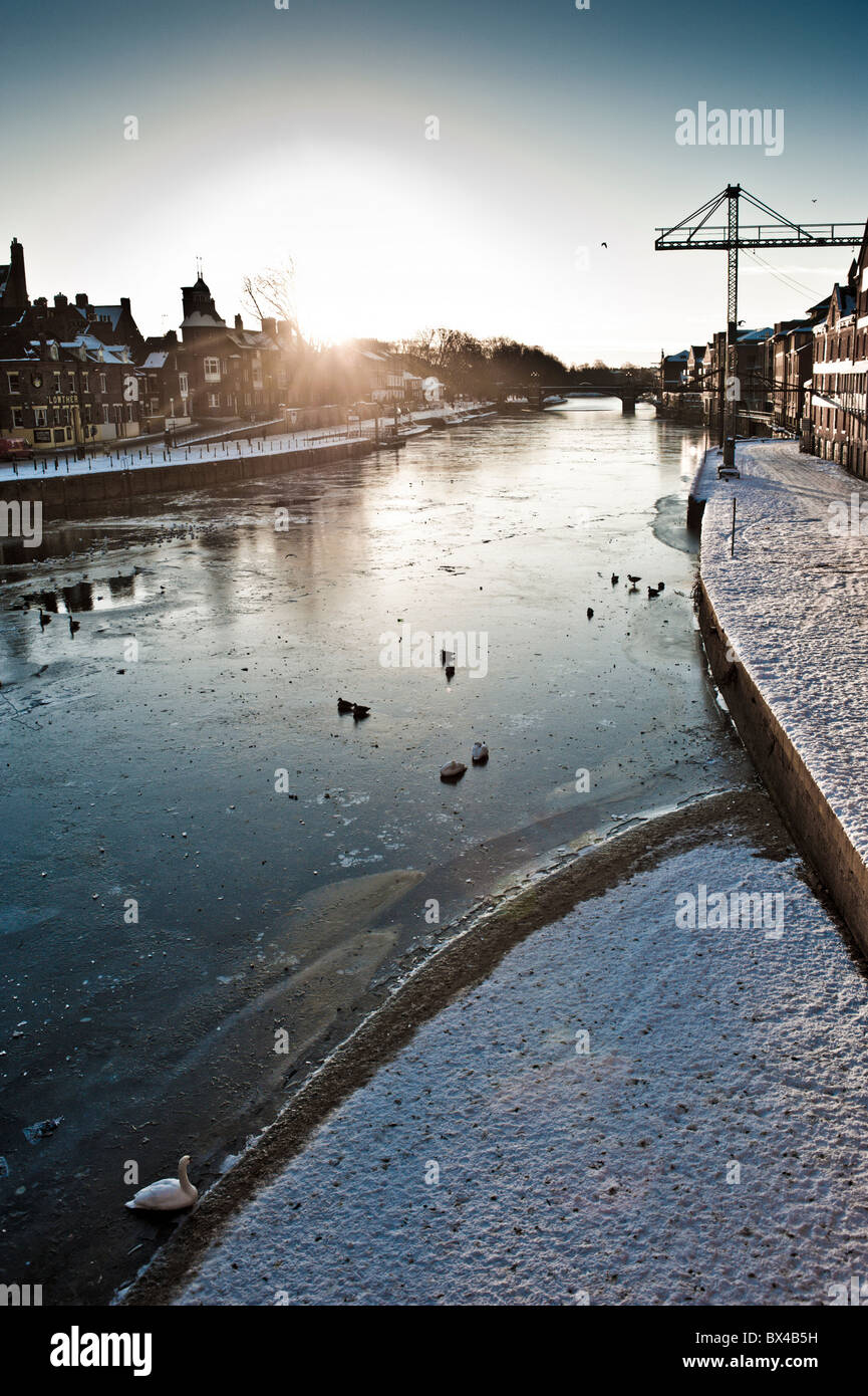 Winter sunrise on Queen's Staith, to the right of the frozen river Ouse ...