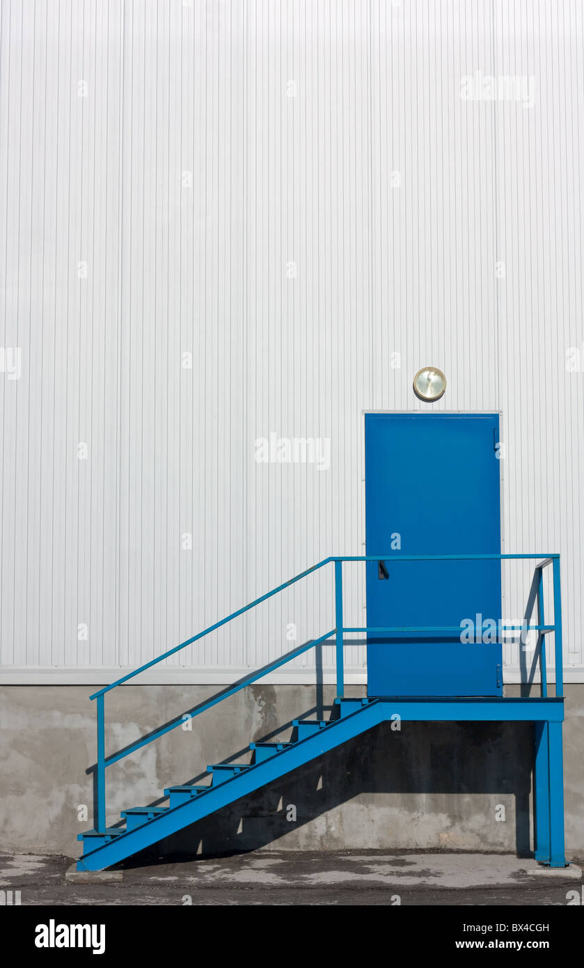 Blue,metal warehouse entry door with stairs Stock Photo - Alamy