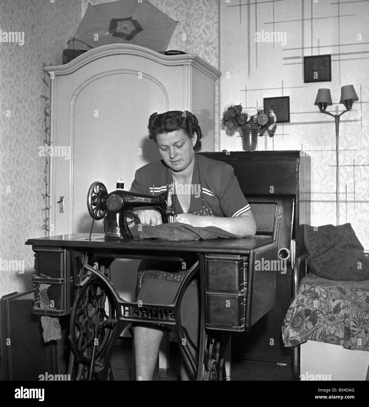 woman sewing Stock Photo - Alamy