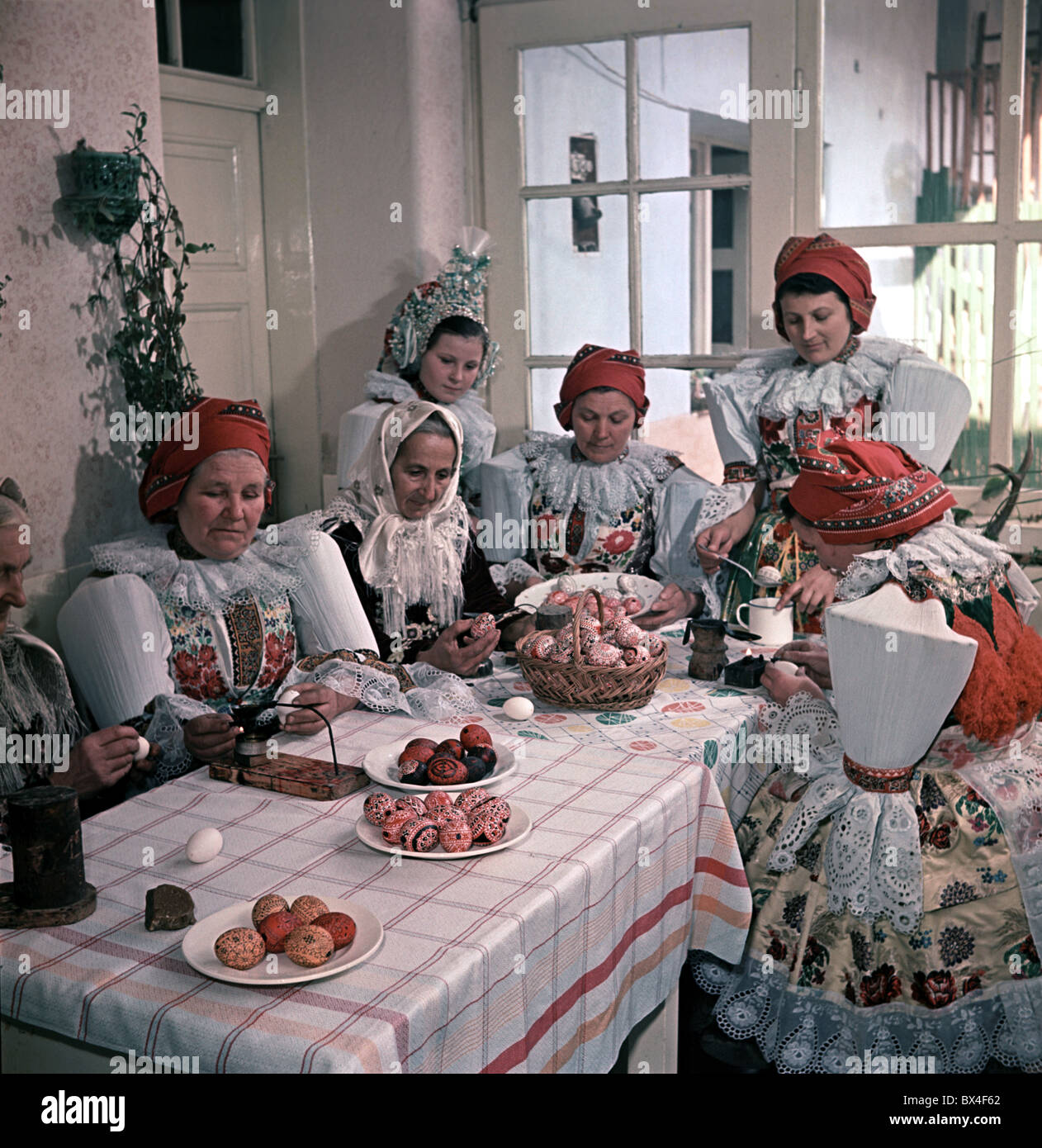 Women wearing traditional dresses handpaint easter eggs hi-res stock ...